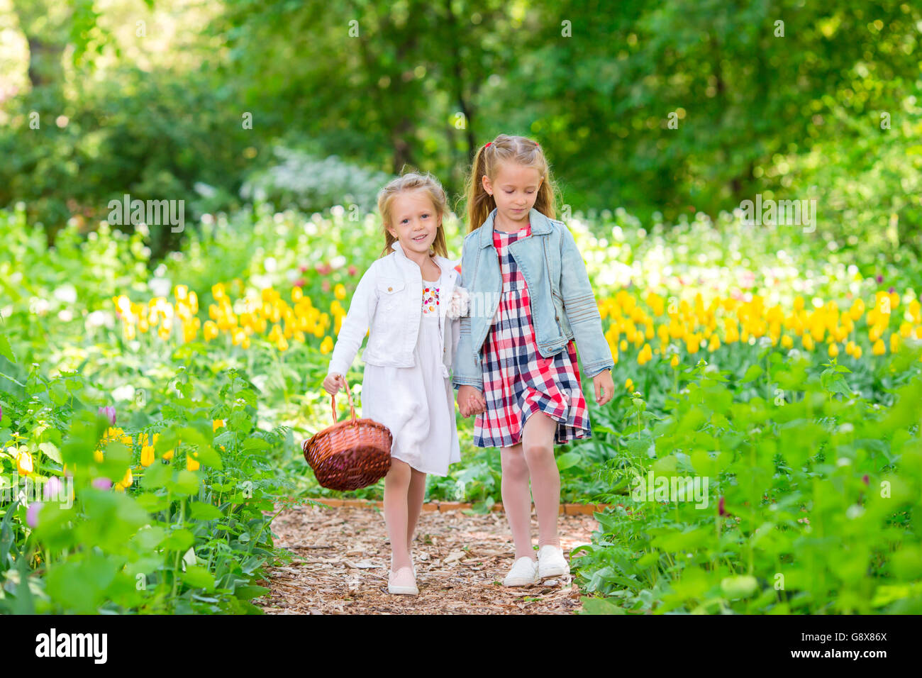 Spring garden, spring flowers, adorable little girls and tulips. Cute ...
