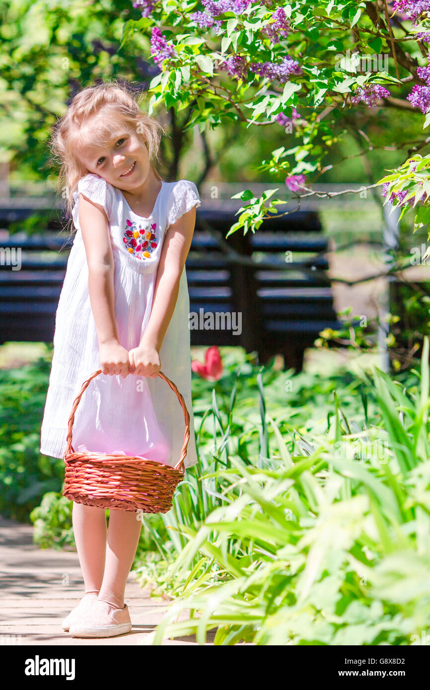Spring garden, spring flowers, adorable little girl and tulips. Cute ...