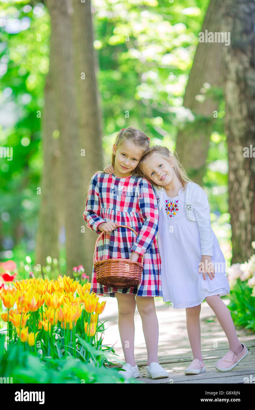 Spring garden, spring flowers, adorable little girls and tulips. Cute ...