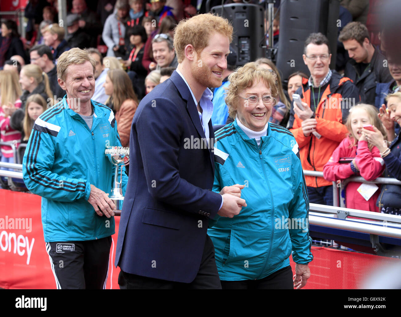 Prince Harry escorts the widow of London Marathon founder John Disley ...