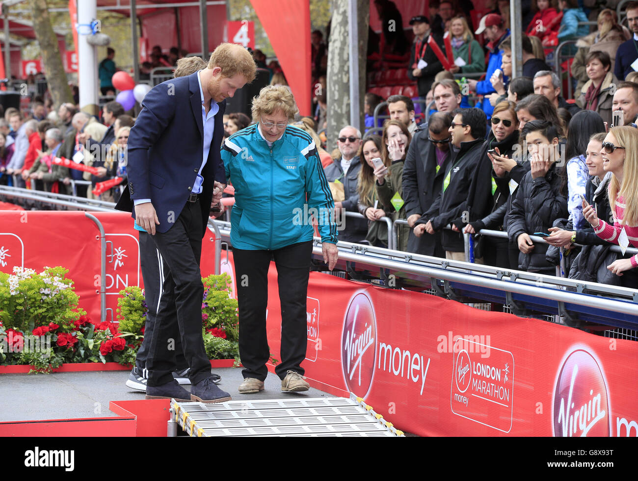 Prince Harry escorts the widow of London Marathon founder John Disley ...