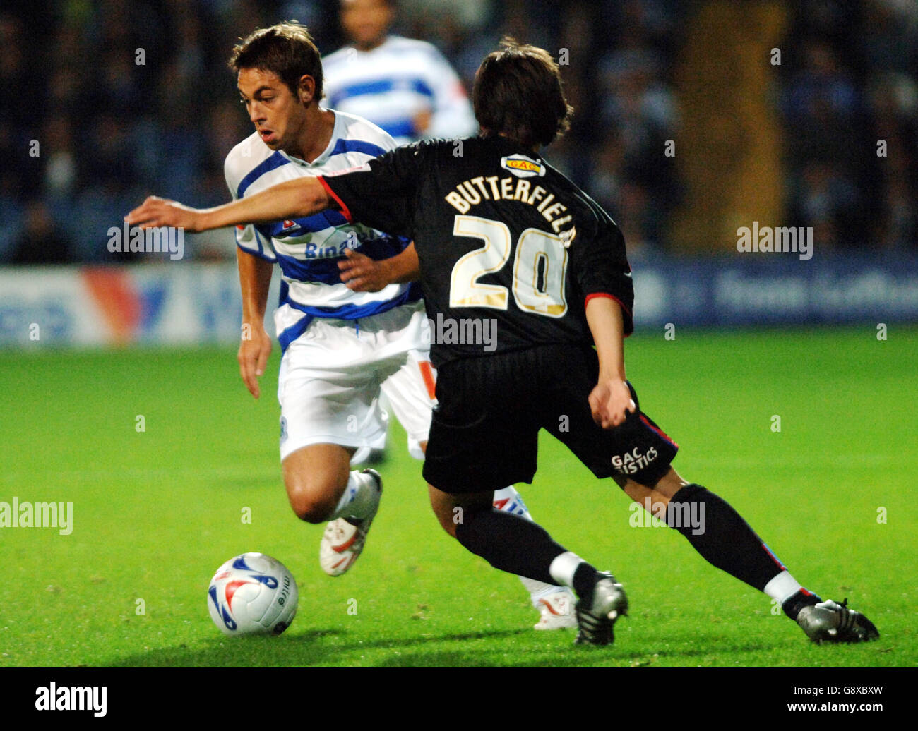 QPR's Lee Cook (L) takes the ball past Crystal Palace's Danny ...