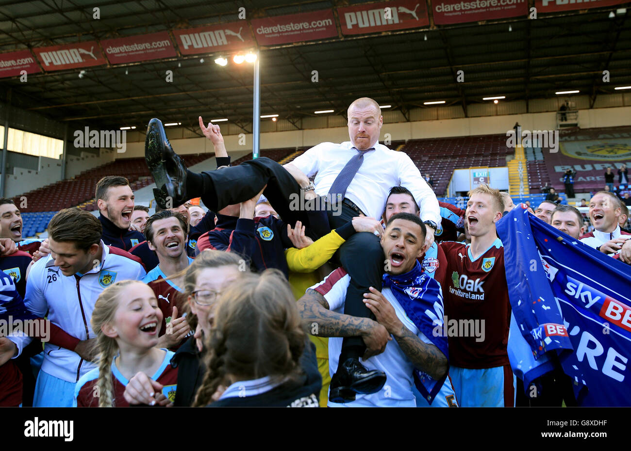 Burnley manager Sean Dyche is hoisted up by the players as they ...