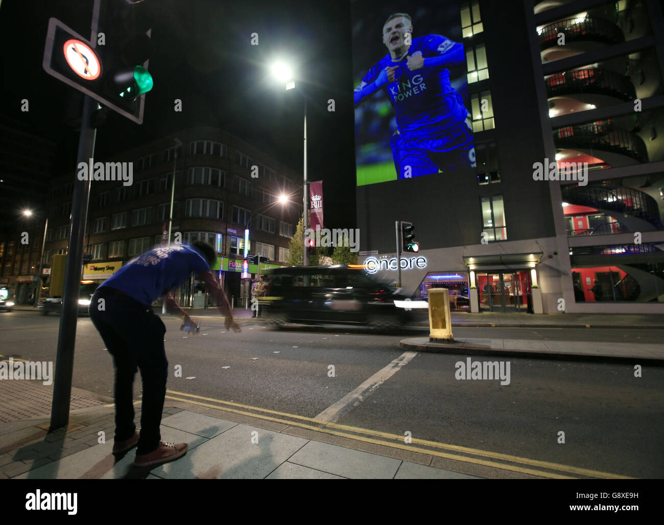 A Leicester City fan bows down to a projection of Jamie Vardy on the ...