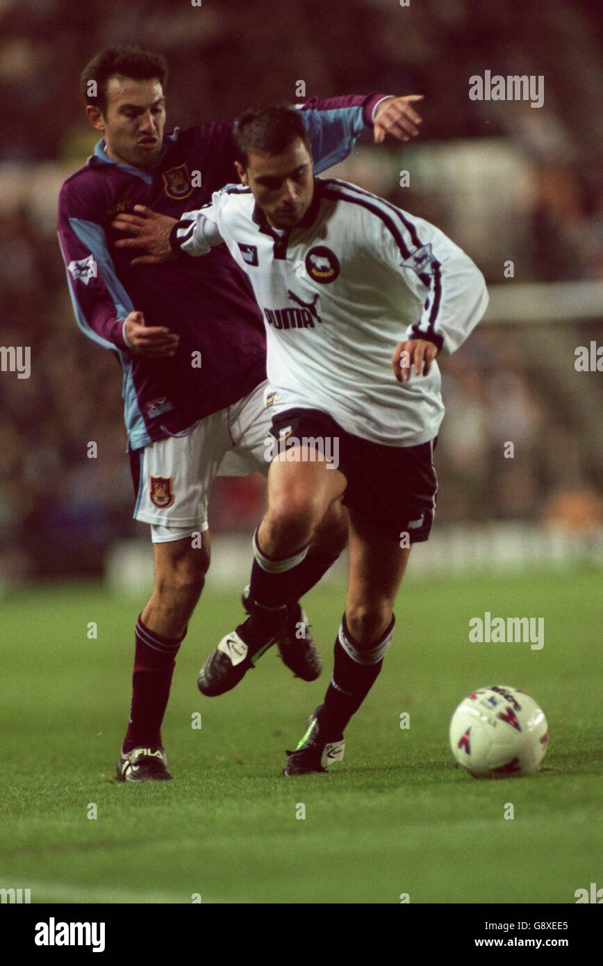 Jonathan Hunt of Derby County (right) holds off West Ham United's Stan ...