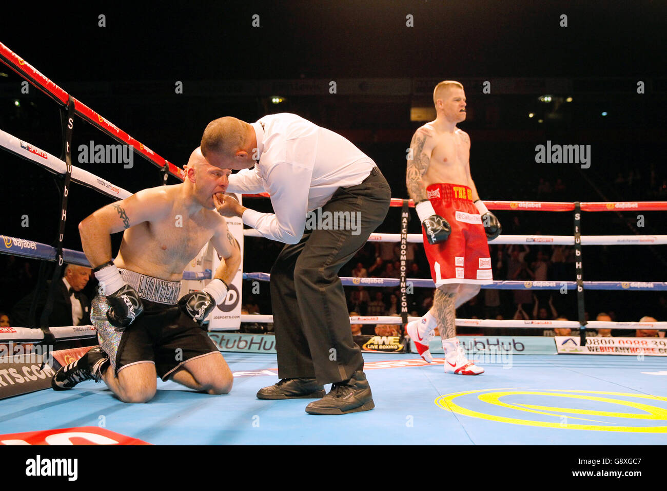 Callum Johnson (right) knocks down Richard Horton in the opening round ...