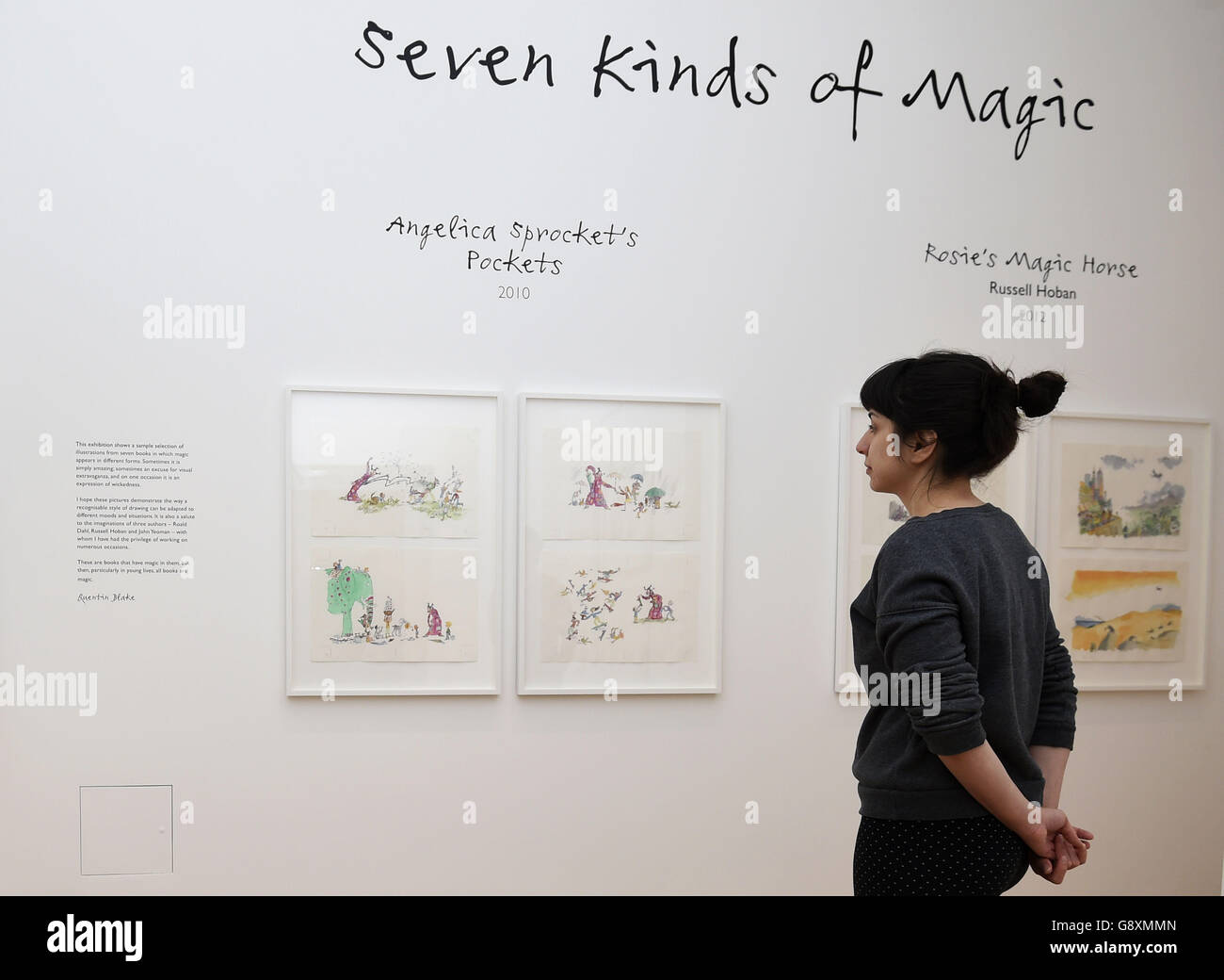 A gallery curator applies the finishing touches to illustrations ...