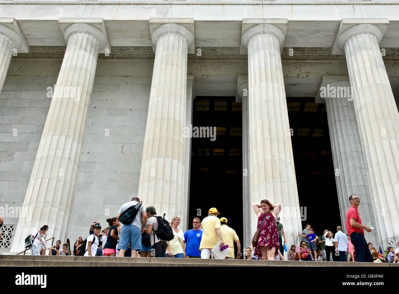 Tourists exploring monuments at the National Mall in Washington DC ...