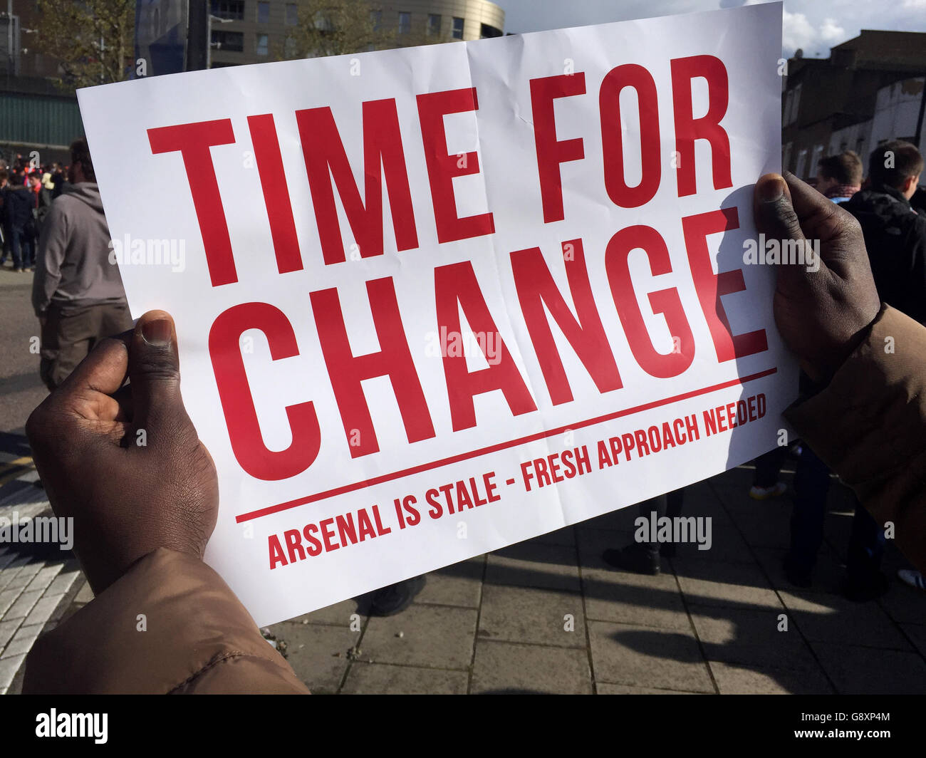 Fans hold signs calling for change at Arsenal, prior to the Barclays ...
