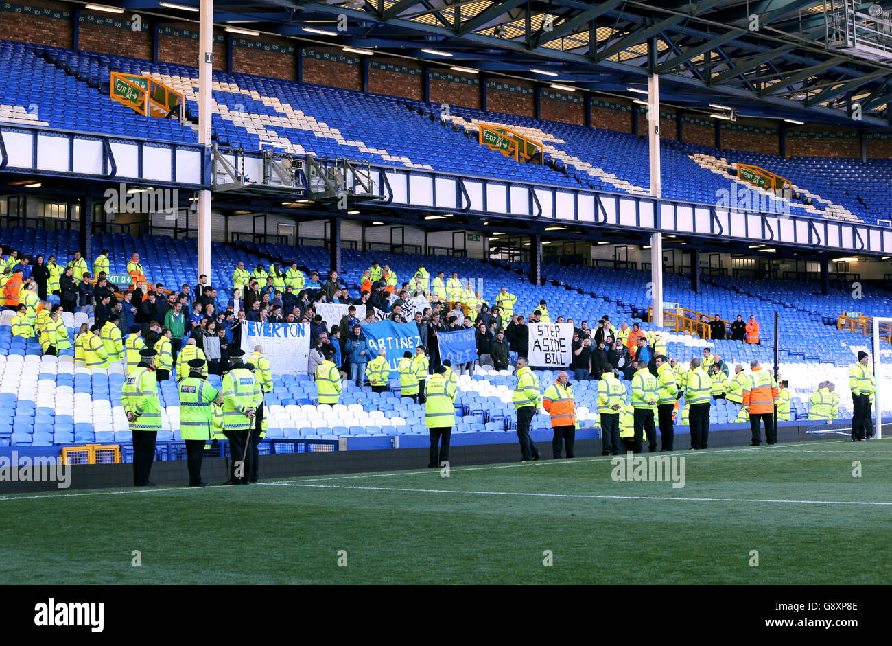 Everton fans stay behind after the match to hold protest signs in the ...