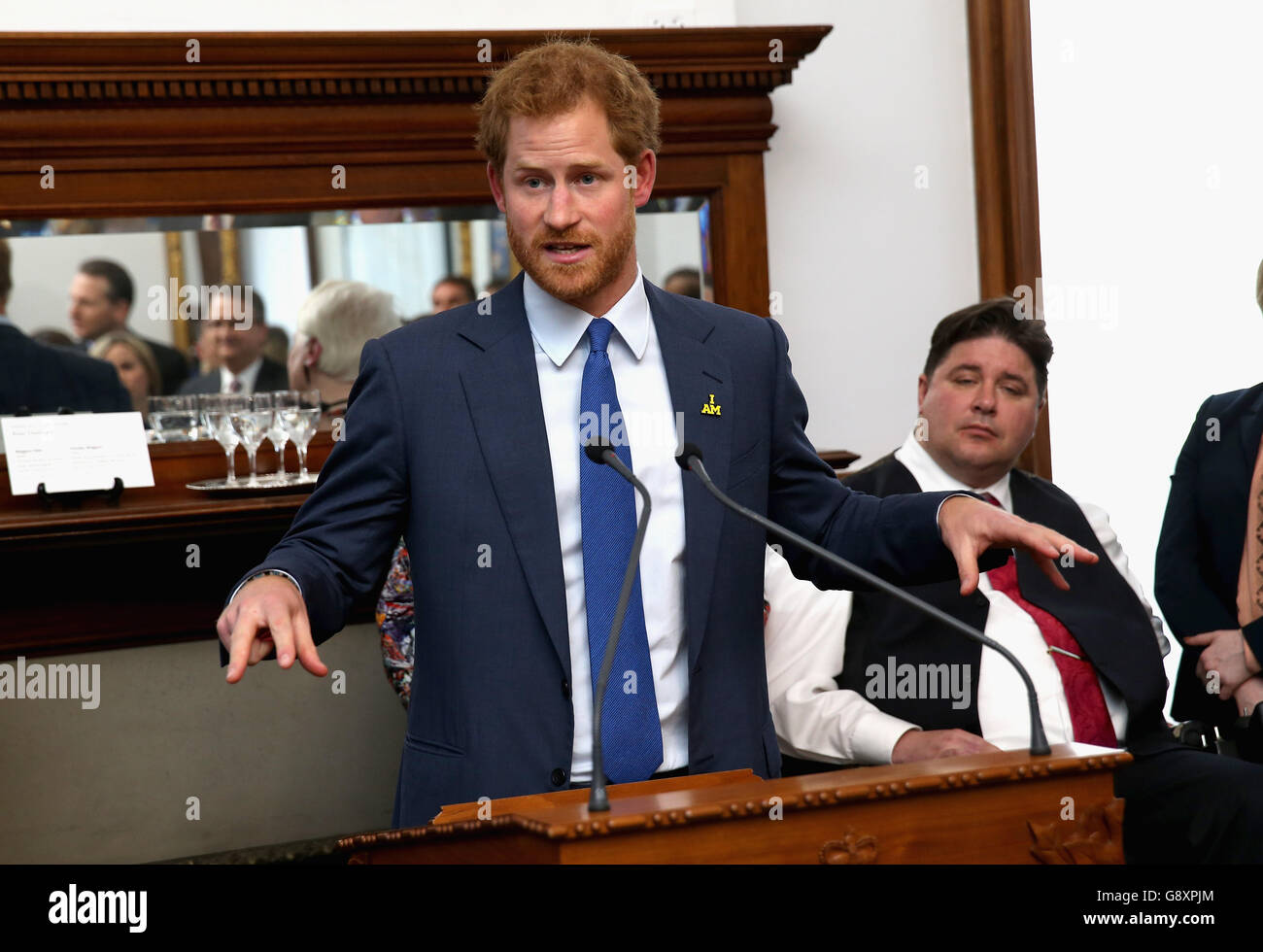 Prince Harry gives a speech as he attends a reception for supporters ...