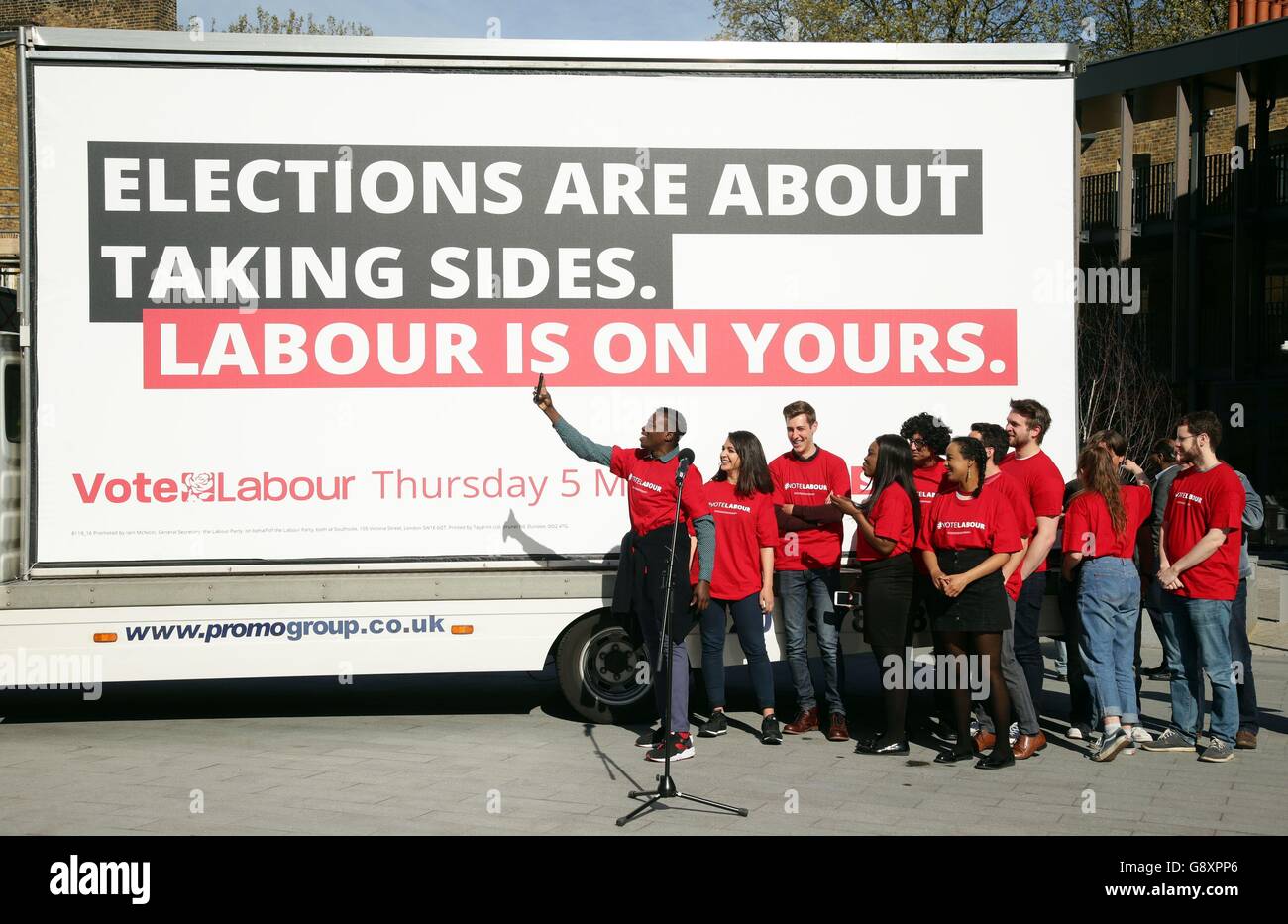 Labour supporters stand by their party's new poster for their election ...