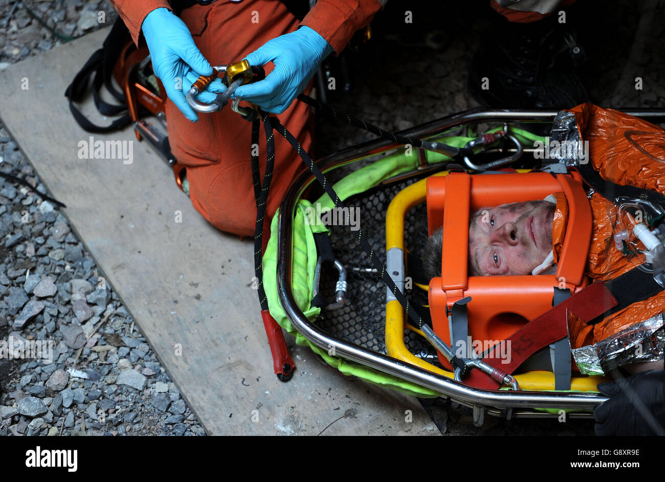An actor on a stretcher is tended to by members of the Hampshire Fire ...