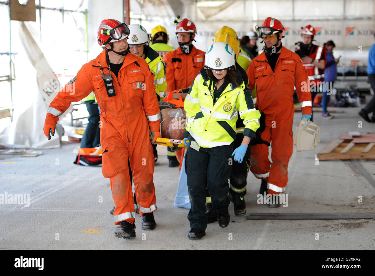 An actor on a stretcher is tended to by members of the Hampshire Fire ...