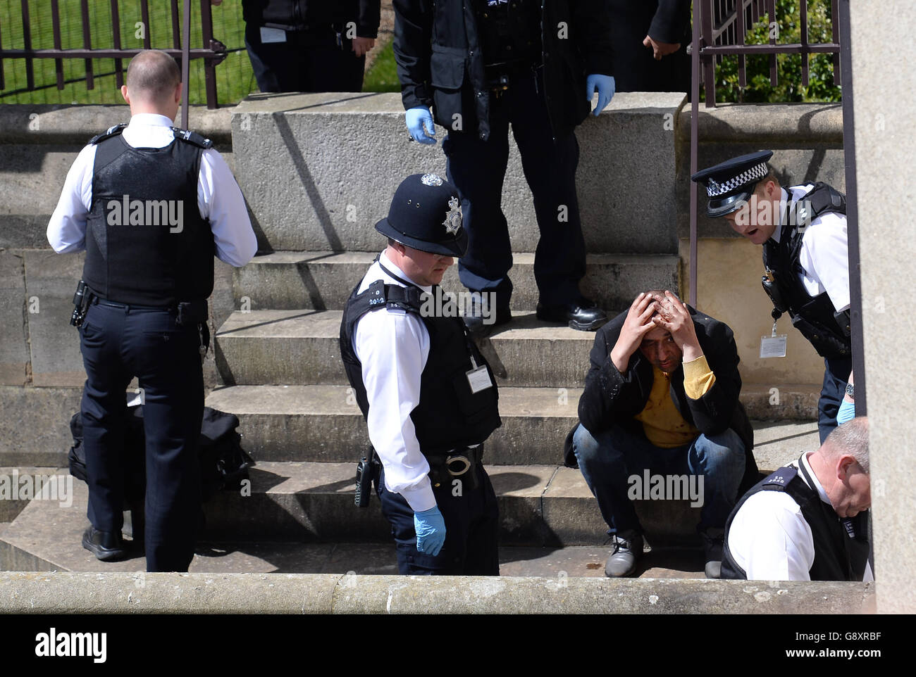 A man is surrounded by police after reportedly falling from Westminster ...