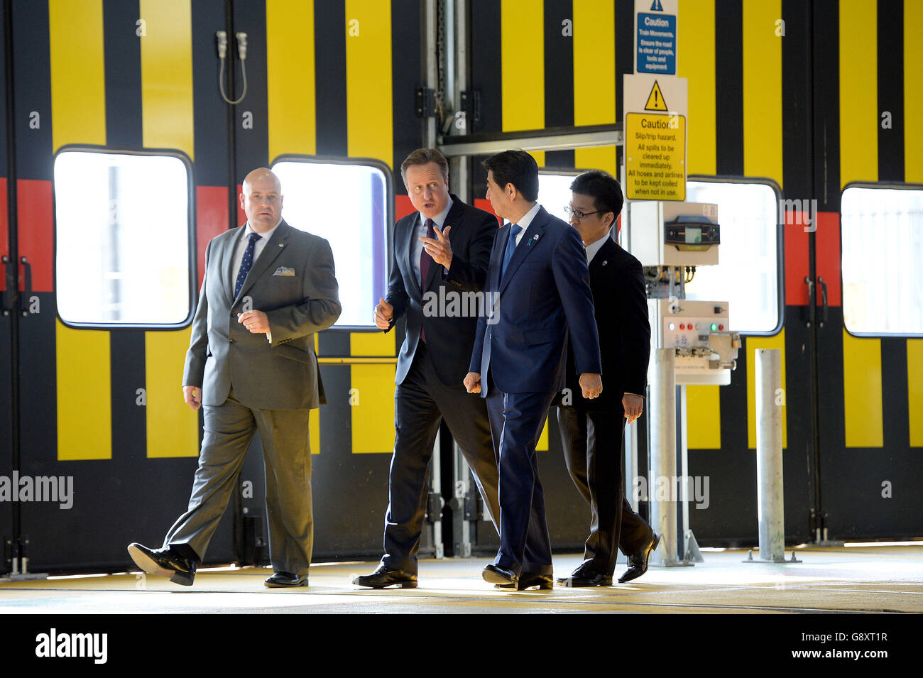 Depot manager George Staines (left), Prime Minister David Cameron and ...