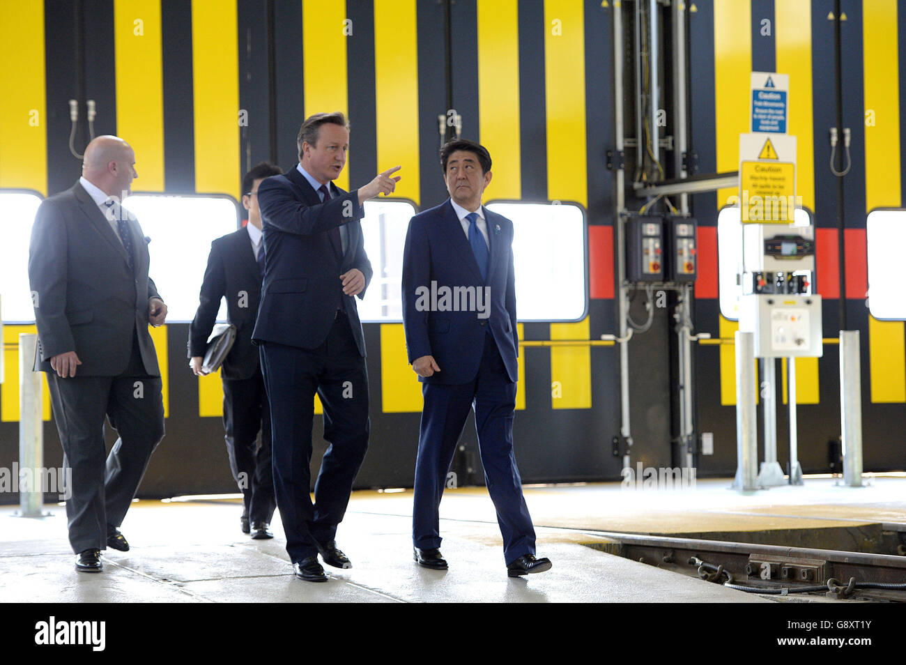 Depot manager George Staines (left), Prime Minister David Cameron and ...