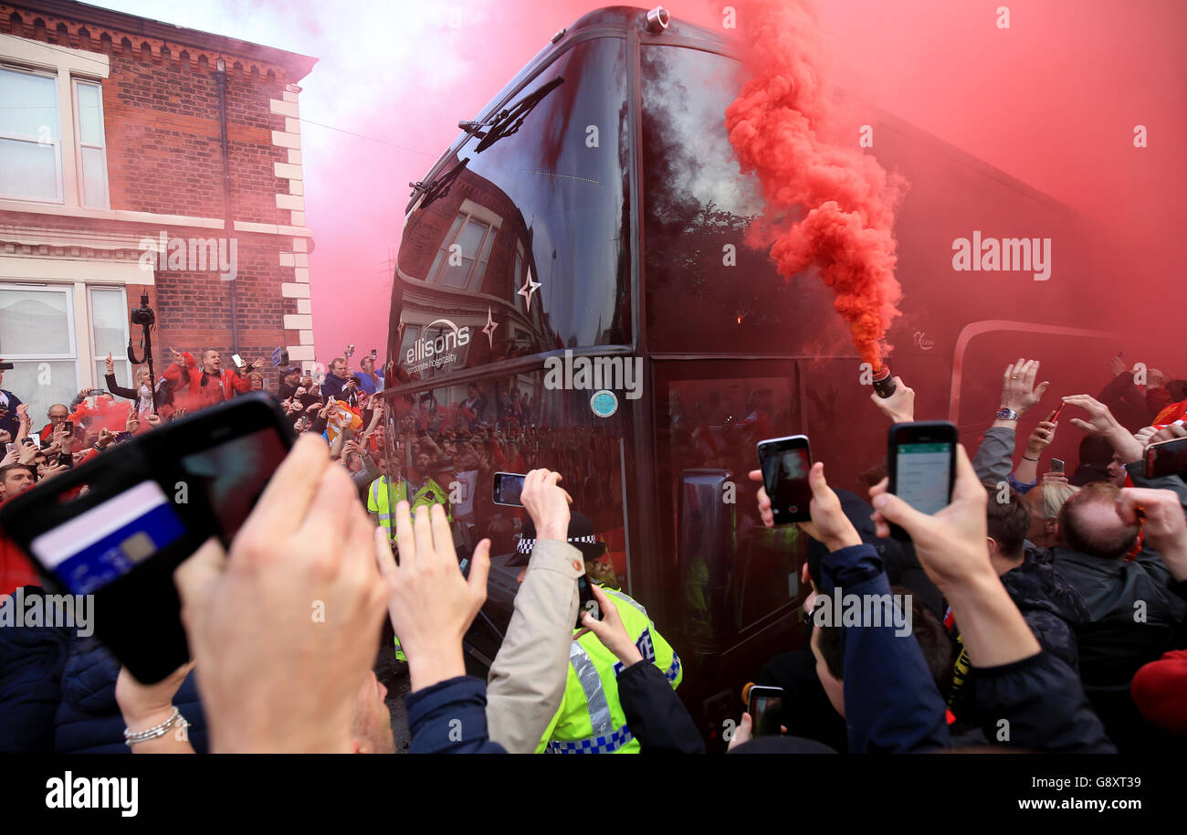 Liverpool fans light flares and surround the Liverpool team bus prior ...