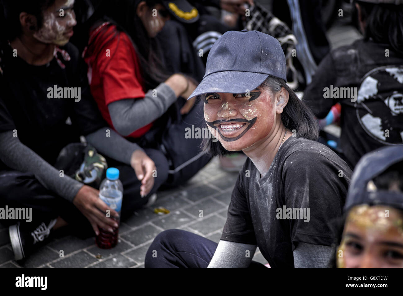 Face paint.Thai teenagers staging a street mocking protest against ...