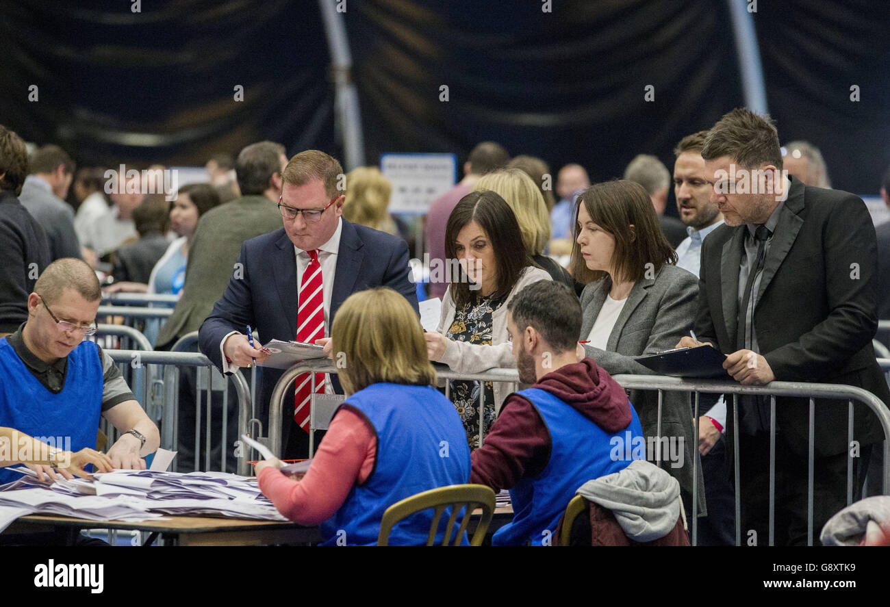 Counting agents watch on volunteers tally ballot papers at the Titanic ...