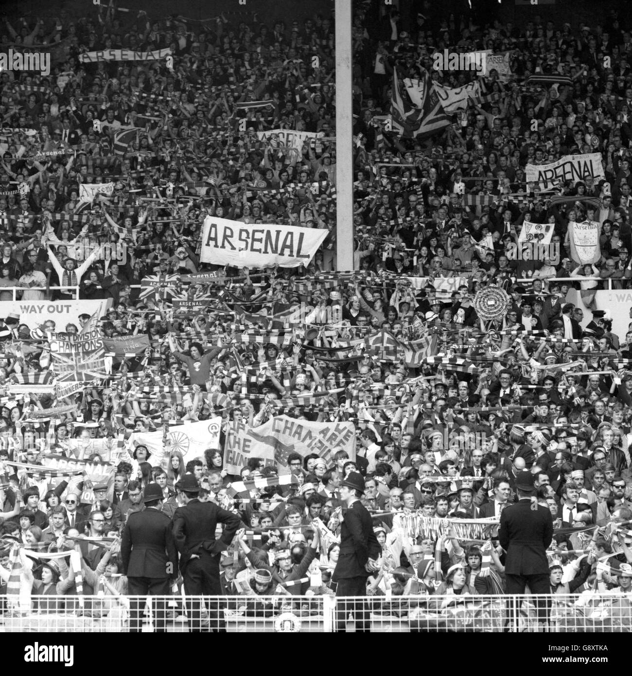 Victorious Arsenal supporters wave banners and flags after their FA Cup ...