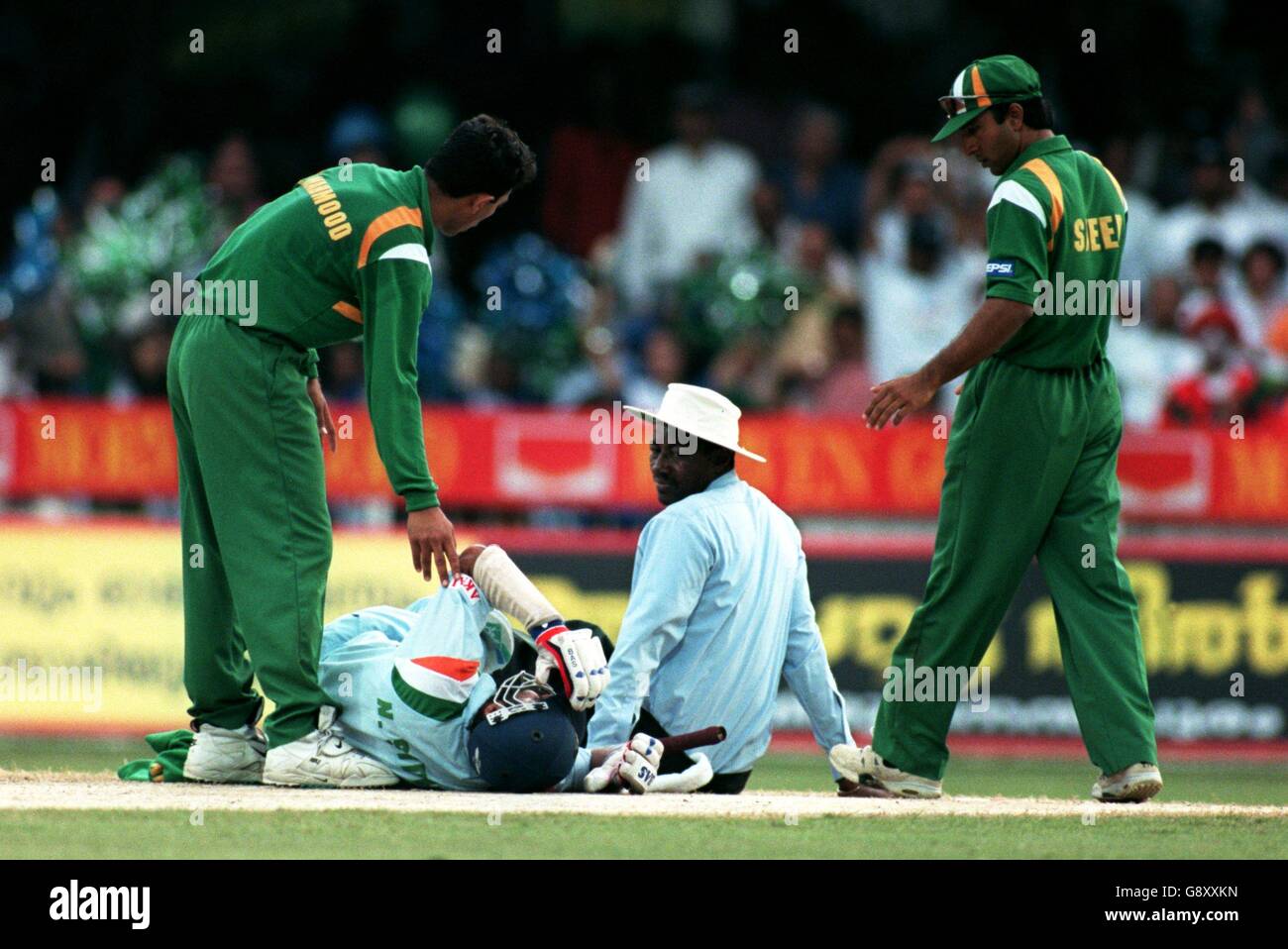 Umpire Steve Bucknor (second right) checks the condition of India's ...