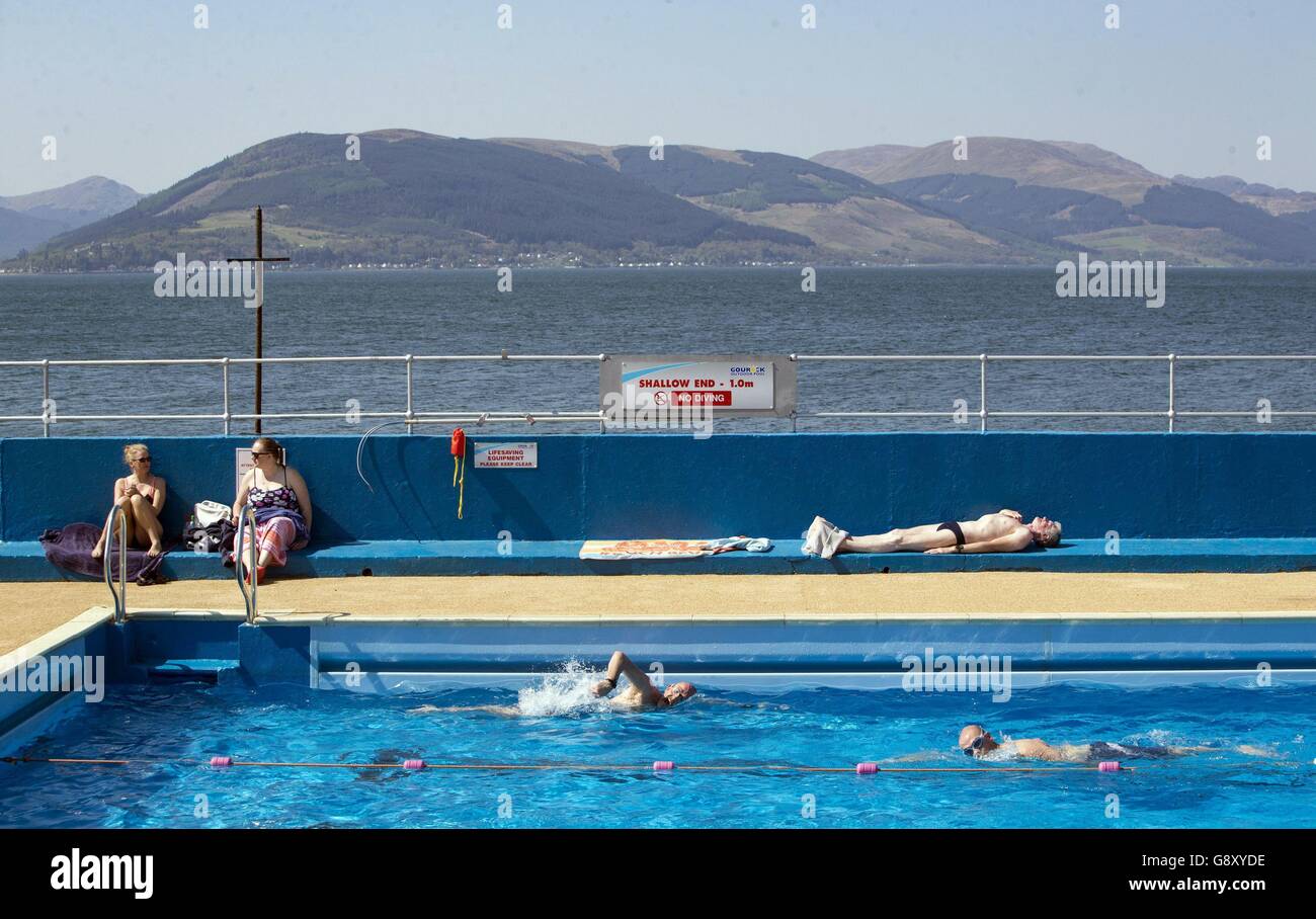 Swimmers and sunbathers enjoy the hot weather at Gourock Outdoor Pool ...