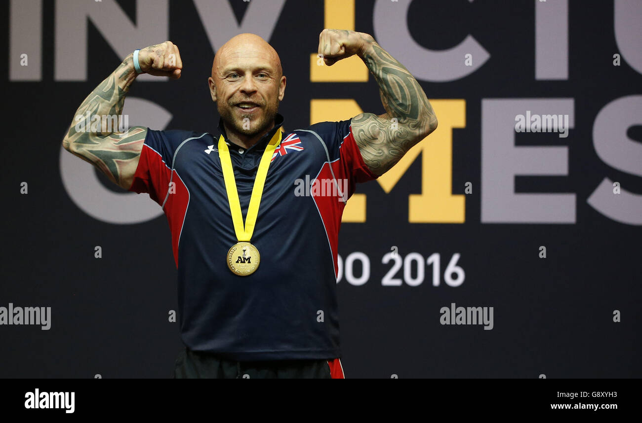 Lightweight weightlifter Michael Yule celebrates after he became the ...