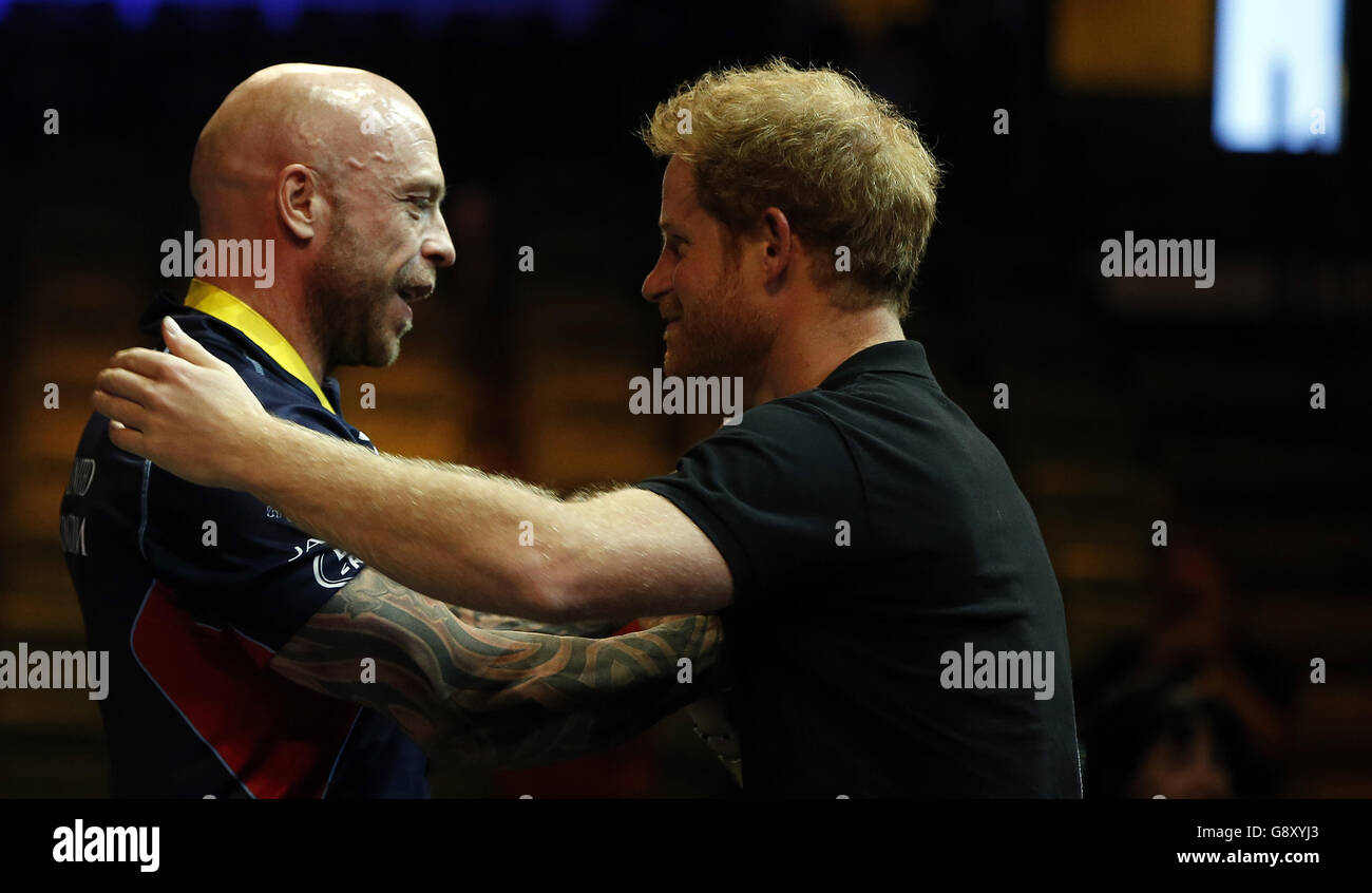 Prince Harry presents a gold medal to lightweight weightlifter Michael ...
