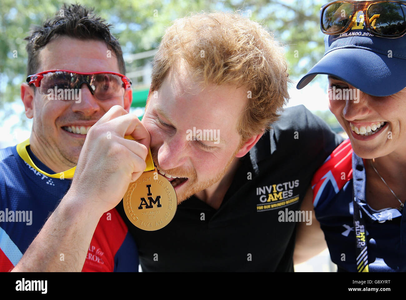 Prince Harry bites Jaco van Gass's (left) gold medal at the road ...
