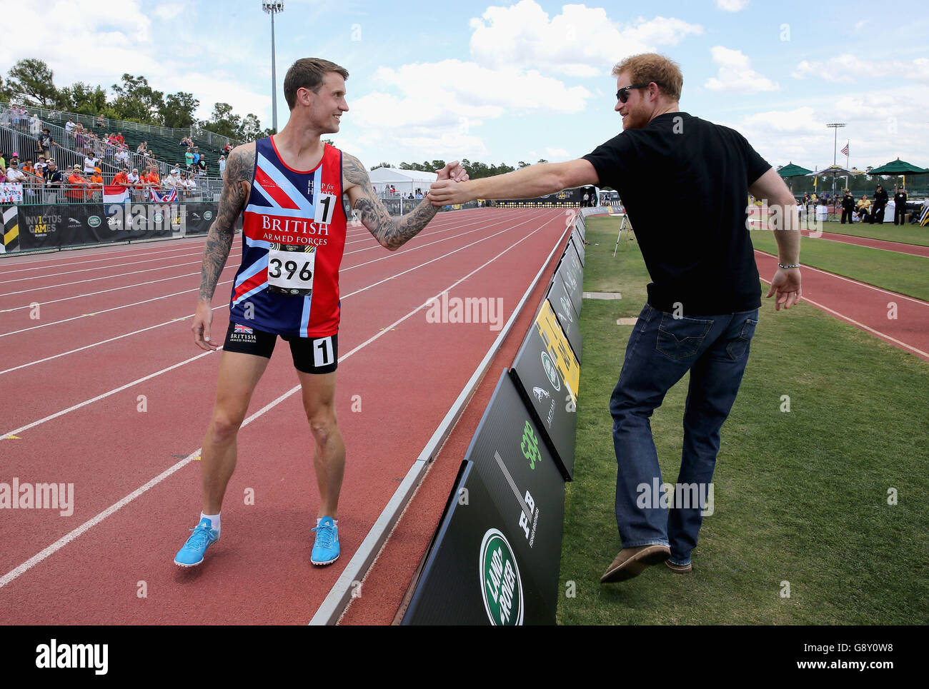 Prince Harry (right) greets a British athlete during the Track and ...