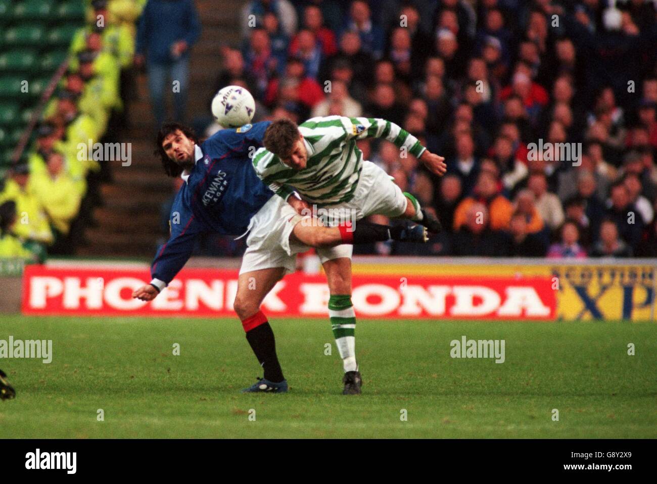 Celtic's Marc Rieper (right) heads the ball away from the boot of ...