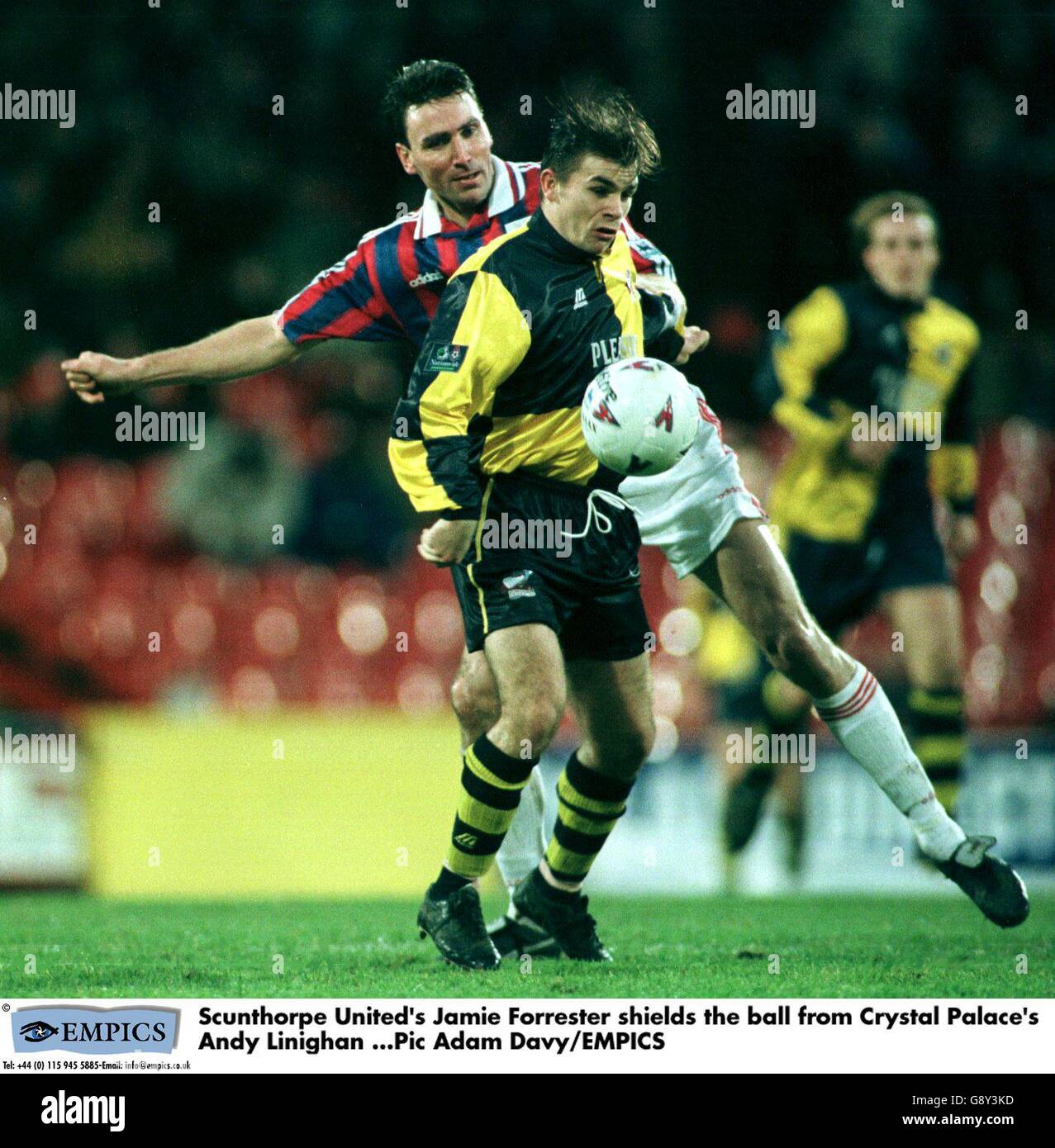 Scunthorpe United's Jamie Forrester (front) shields the ball from ...