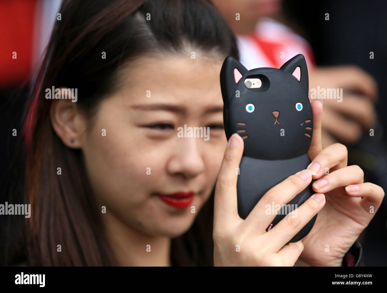 A fan takes a photograph on their mobile phone during the Barclays ...