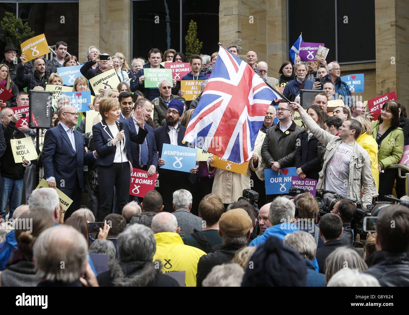 A man holds a union flag as First Minister and SNP leader Nicola ...