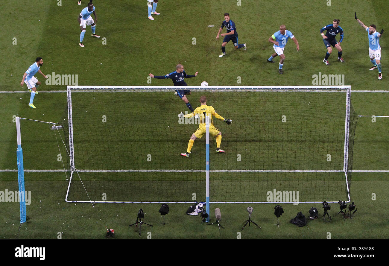 Manchester City goalkeeper Joe Hart saves from Real Madrid's Pepe Stock ...