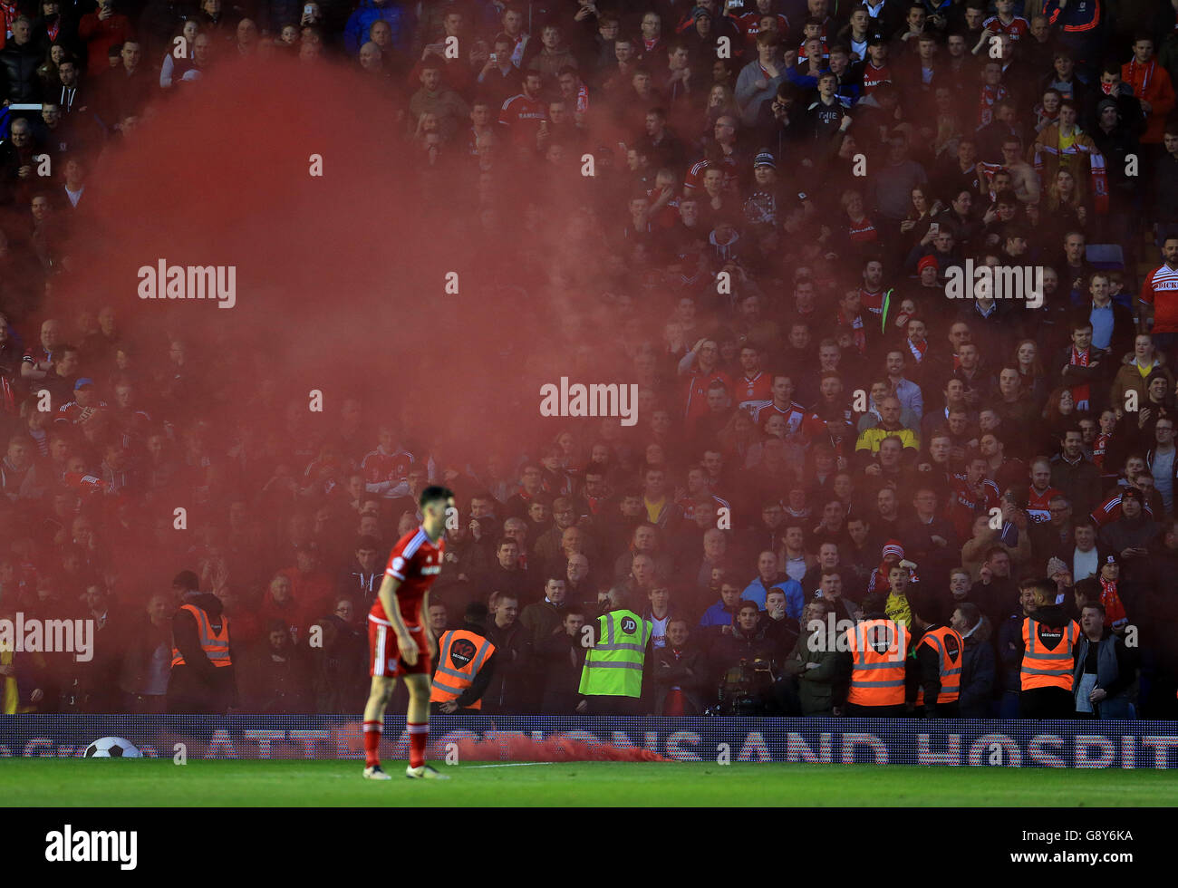 A general view of Middlesbrough fans in the stands as a flare goes off ...