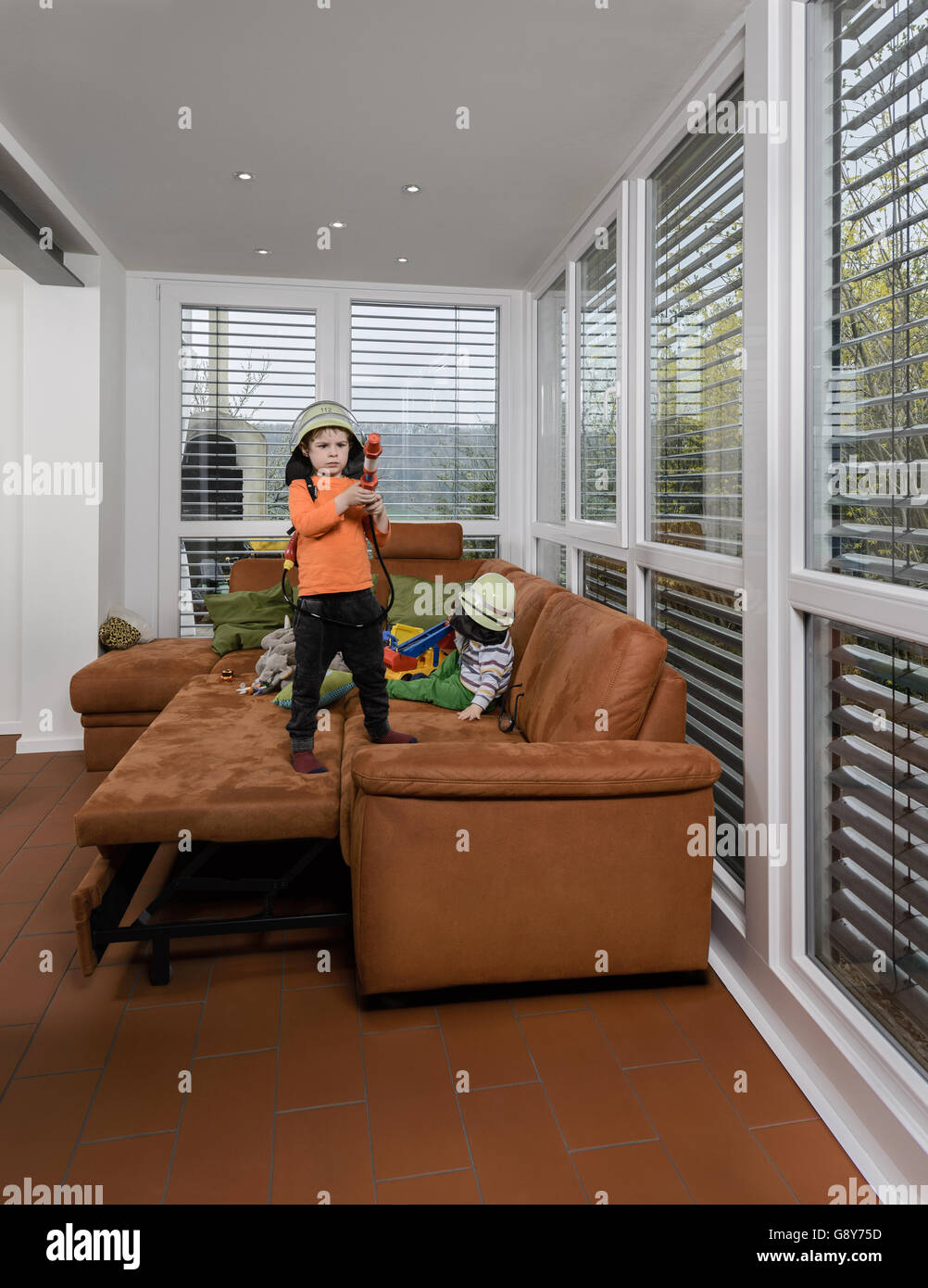 Children playing fireman in the living room interior Stock Photo - Alamy