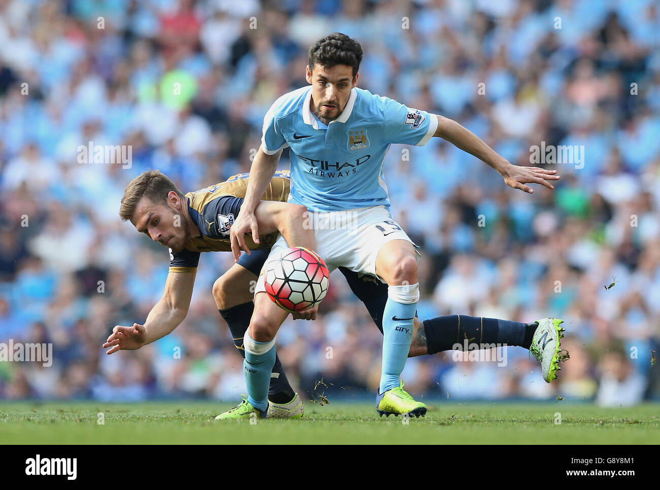 Arsenal's Aaron Ramsey (left) and Manchester City's Jesus Navas battle ...