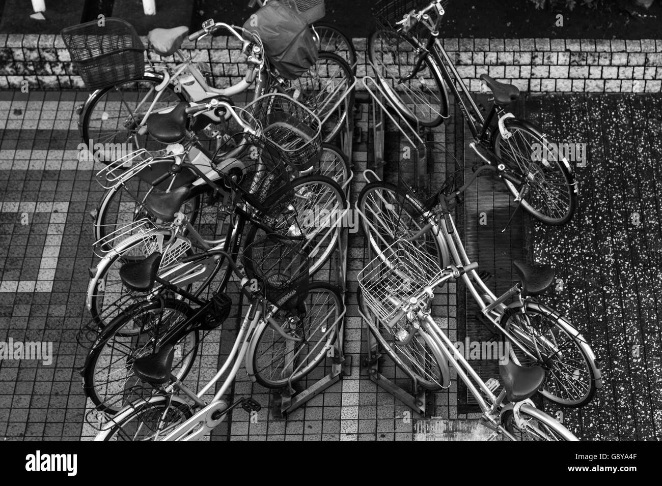 Many bikes are crowded into this bike rack in downtown Tokyo, Japan ...