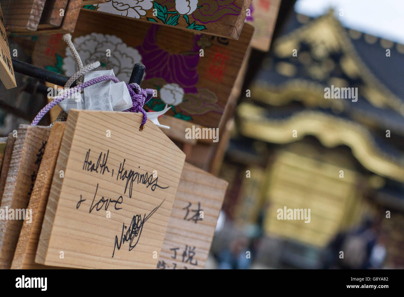Asking for good fortune outside a Japanese shrine outside of Ueno Park ...