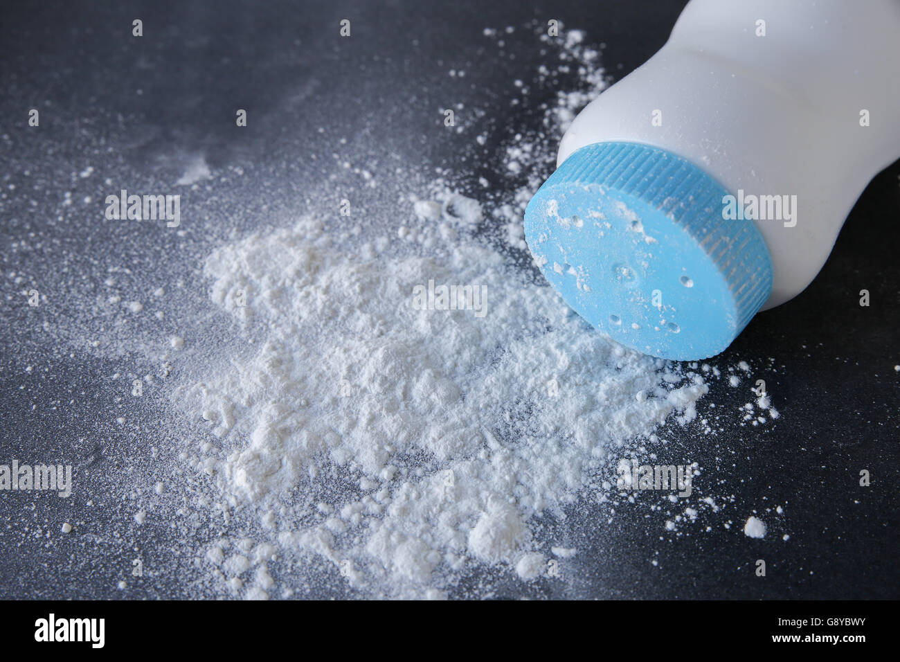 Talcum powder on black background Stock Photo - Alamy