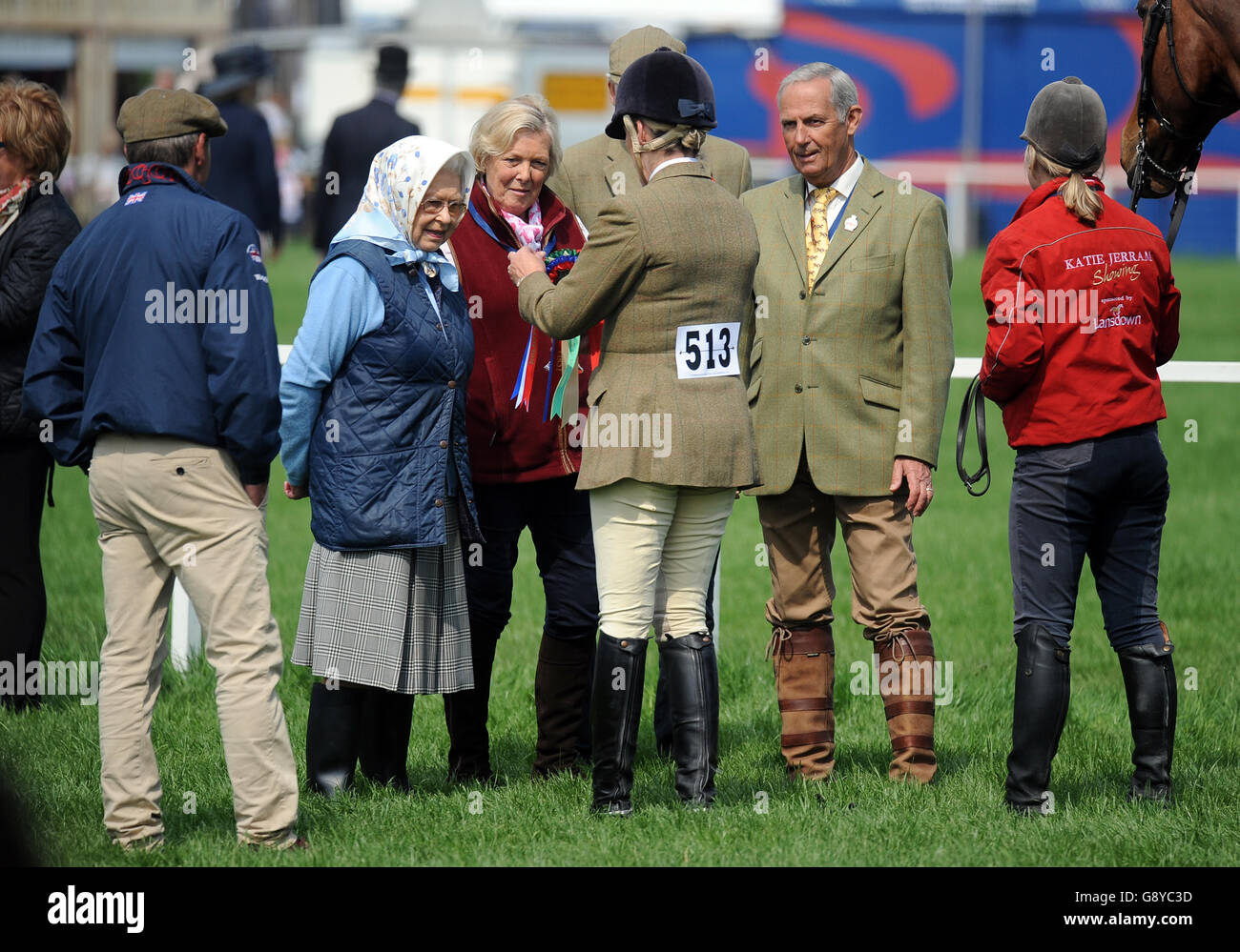 Queen Elizabeth II (left) is shown her trophy after her horse Barber's ...