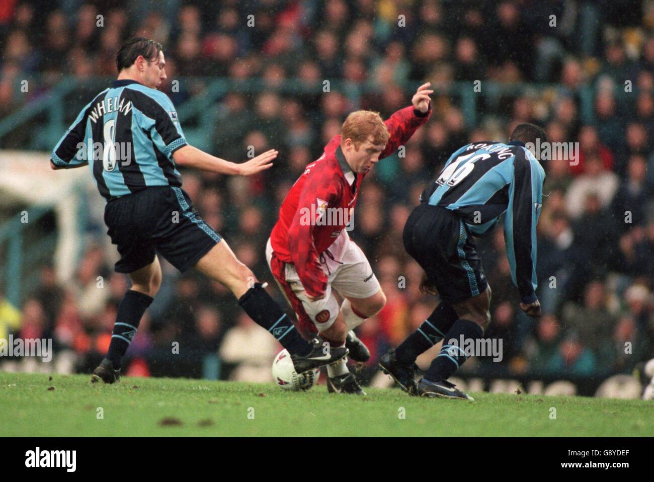 Paul Scholes of Manchester United (centre) is stopped by Coventry City ...