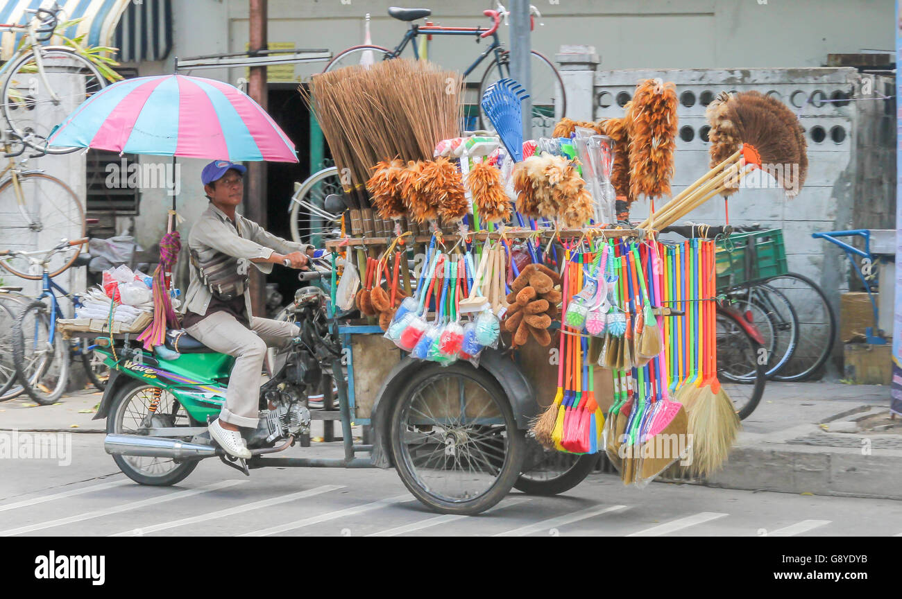 A mobile brush vendor on a three wheeled motorcycle Stock Photo - Alamy