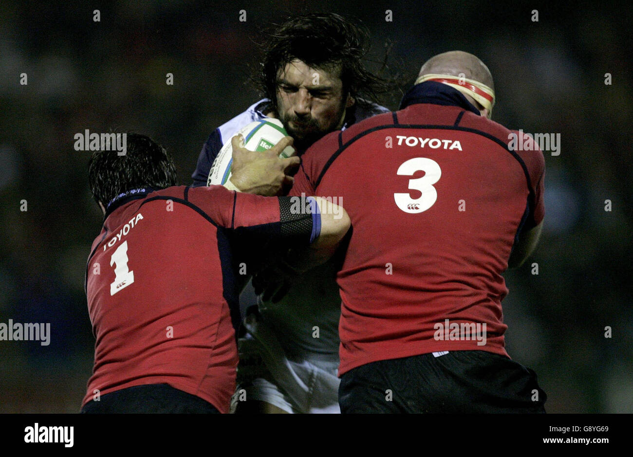 Sale Shark's Sebastien Chabal (C) is stopped by Munster's Marcus Horan ...