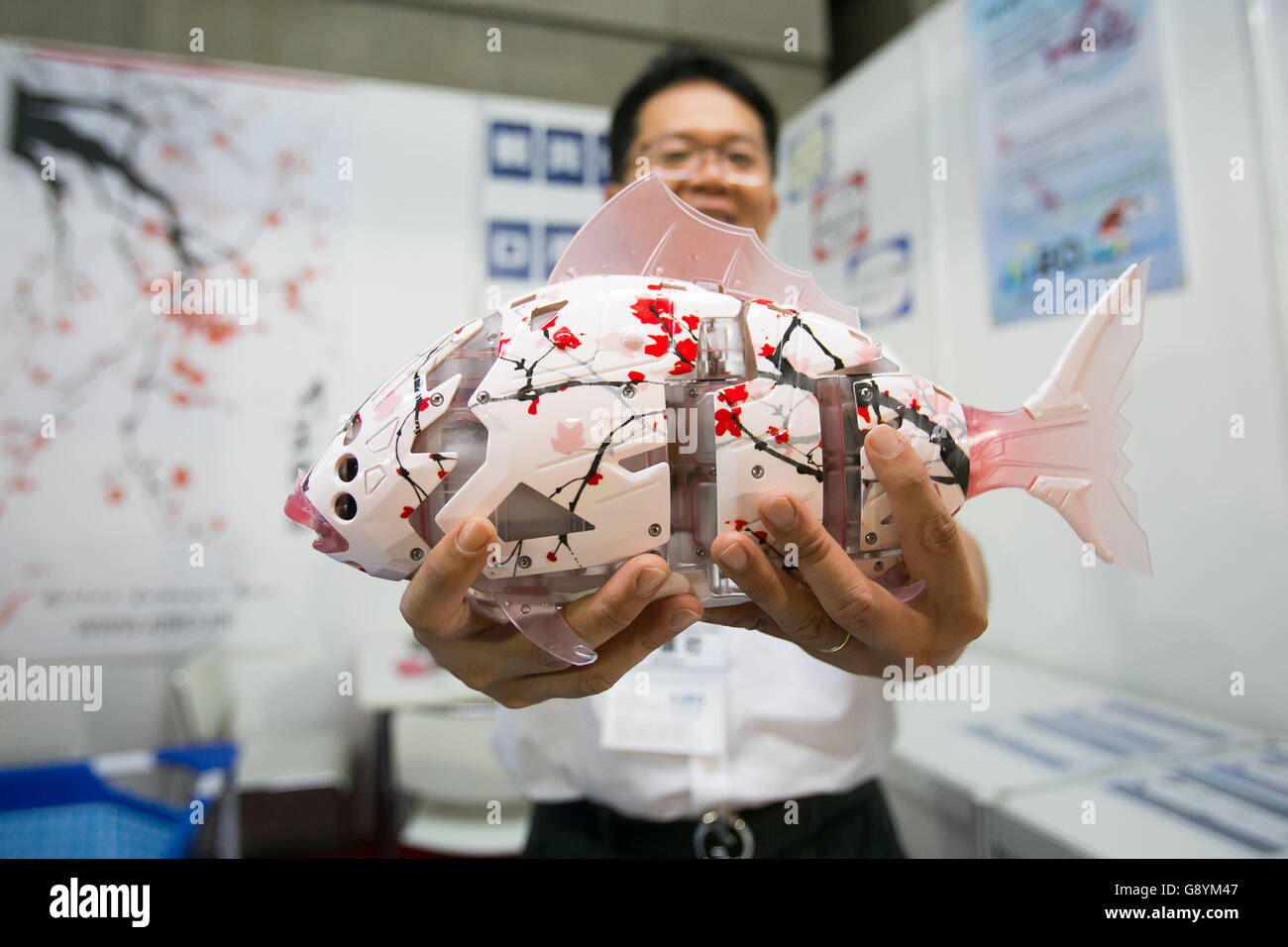 Tokyo, Japan. 30th June, 2016. An exhibitor shows a fish robot MIRO ...