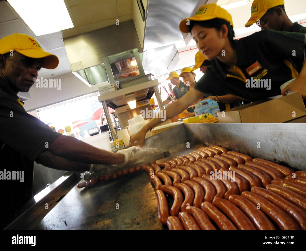New York, US. 29th June, 2016. Employees preparing Hot Dogs at 'Nathan ...