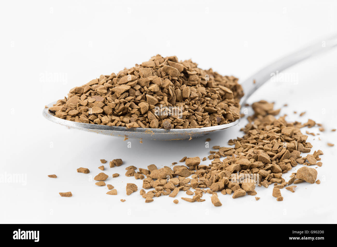 Close focus on premium brown decaf coffee powder putting on stainless ...