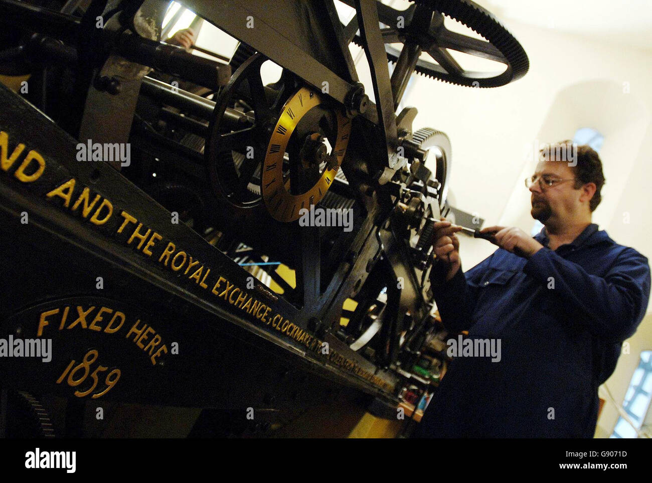 Trainee Clock Mechanic Huw Smith makes adjustments to the settings of ...